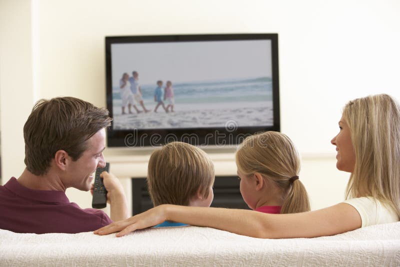 Family Watching Widescreen TV At Home Stock Photo - Image: 55890835
