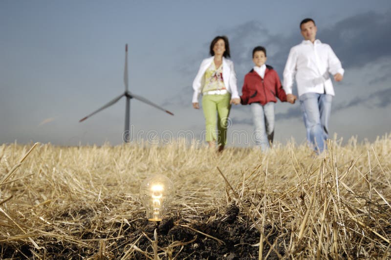 Family and Wind Turbines, Light Bulb in the Ground Stock Photo - Image ...