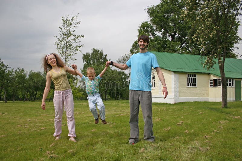 Family in yard stock image. Image of love, jump, garden - 1544427