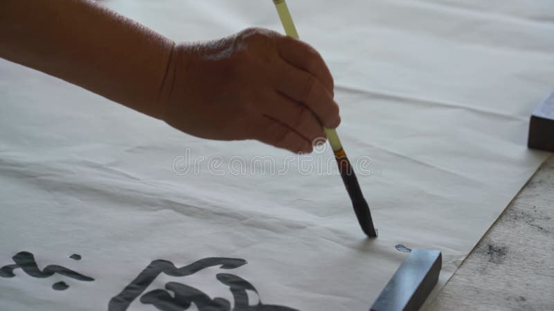 A Famous Chinese Calligrapher Writes with a Brush, Creating a ...