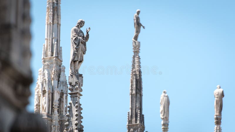 Famous Milan Cathedral with Statues Against a Blue Sky Stock Photo ...