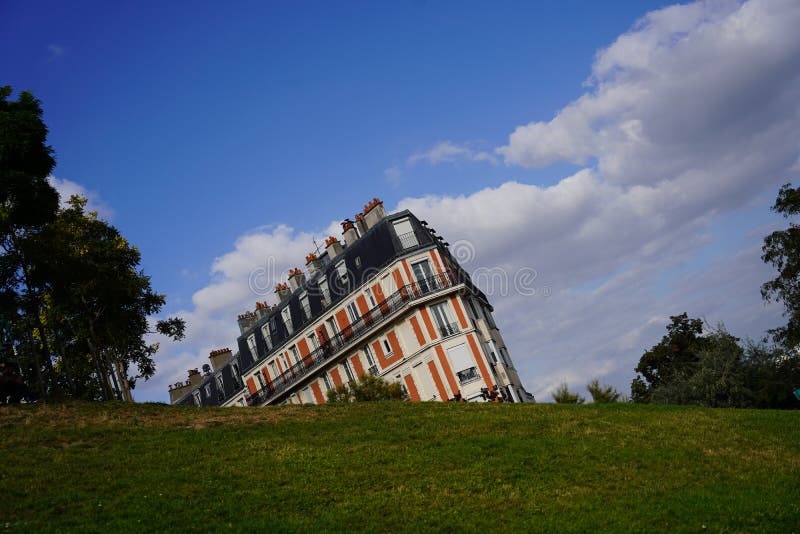 Famous Sinking House is in Montmartre Against a Blue Cloudy Sky Next To ... Famous Sinking House is in Montmartre Against a Blue Cloudy Sky Next To ...