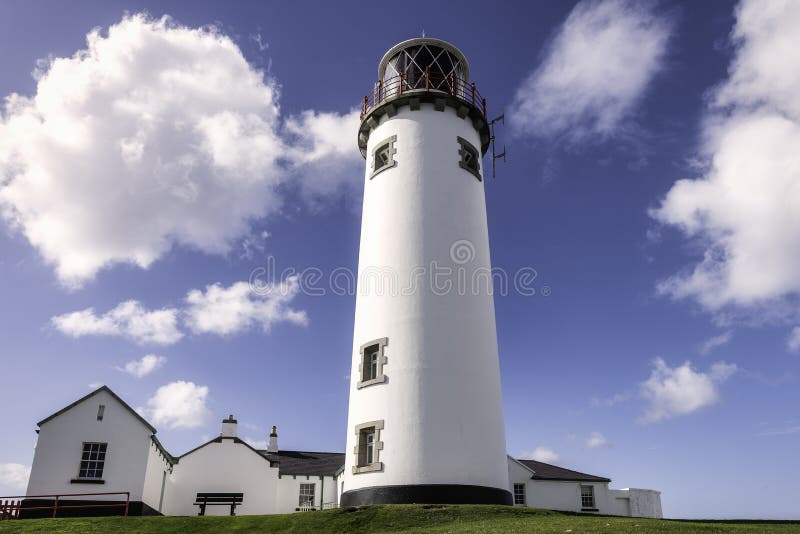 Lighthouse with a Bright Blue Sky Stock Photo - Image of ocean, clouds ...