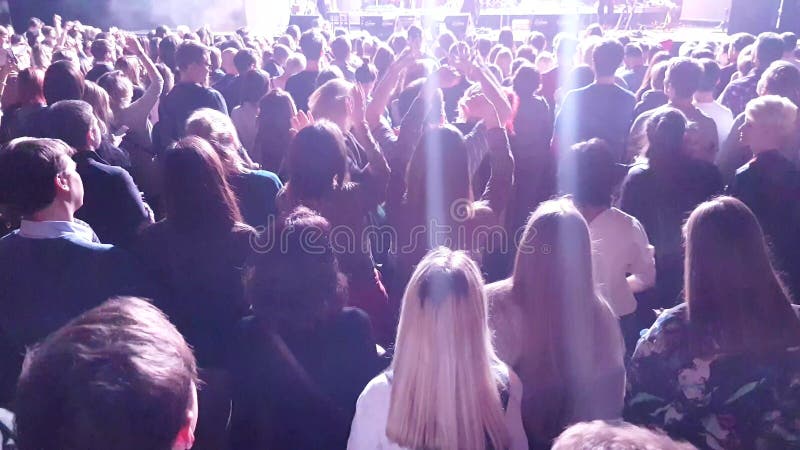 Fans Cheering in Audience Waving Their Hands and Hold Mobile Phones ...