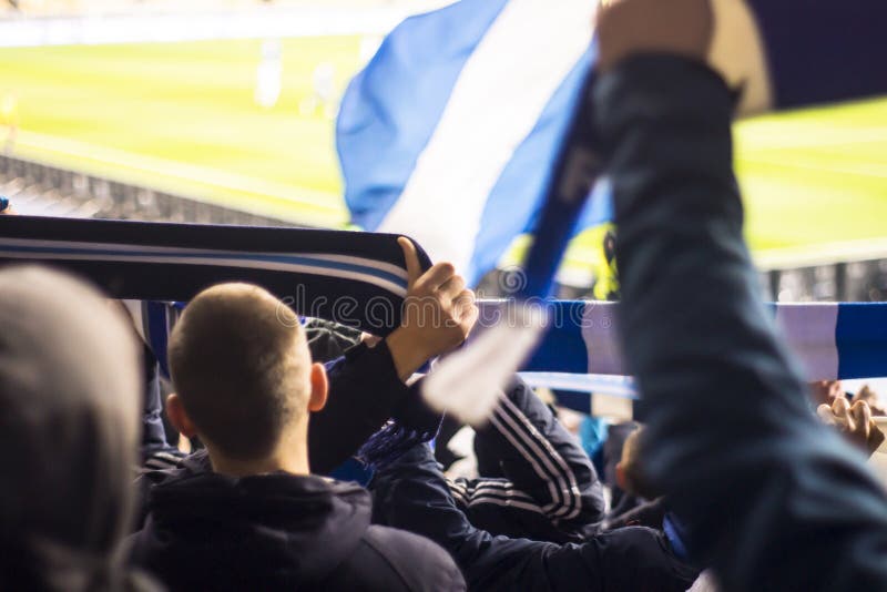 Fans in the Stadium Holding Flags of Their Football Team Editorial ...