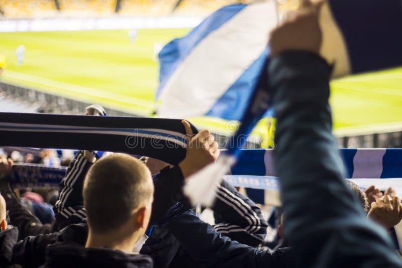 Fans in the Stadium Holding Flags of Their Football Team Editorial ...
