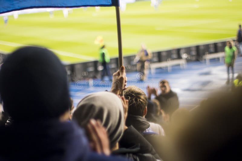 Fans in the Stadium Holding Flags of Their Football Team Editorial ...