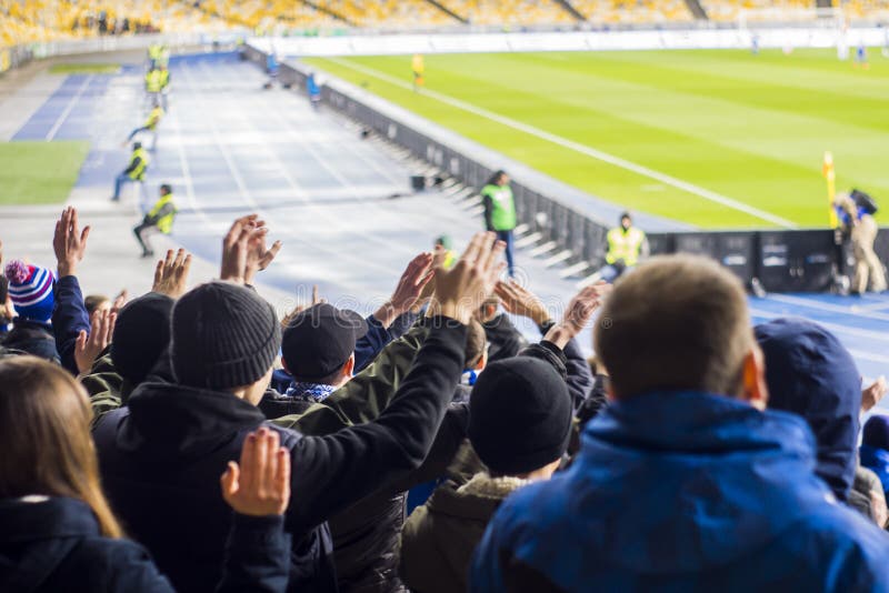 Fans in the Stadium Holding Flags of Their Football Team Editorial ...