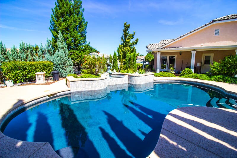Fantastic Side Yard Setting with Blue Swimming Pool Stock Photo - Image ...