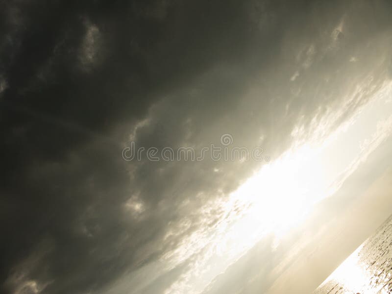 Silver Sunset Above the Sea, Sun Shining through the Clouds. Stock ...