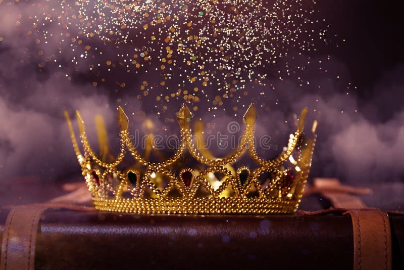 Fantasy World. Beautiful Golden Crown Lit by Magic Light on Suitcase ...