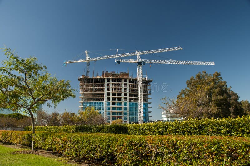 Far Shot of an Image of White Crane Towers at a Large Construction Site ...