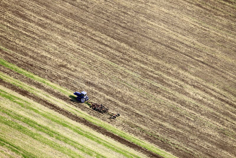 An Aerial View of a Tractor Plowing in a Field. Stock Photo - Image of ...
