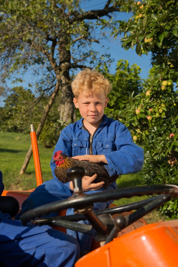 Farm Boy with tractor stock photo. Image of lifestyle - 61313742