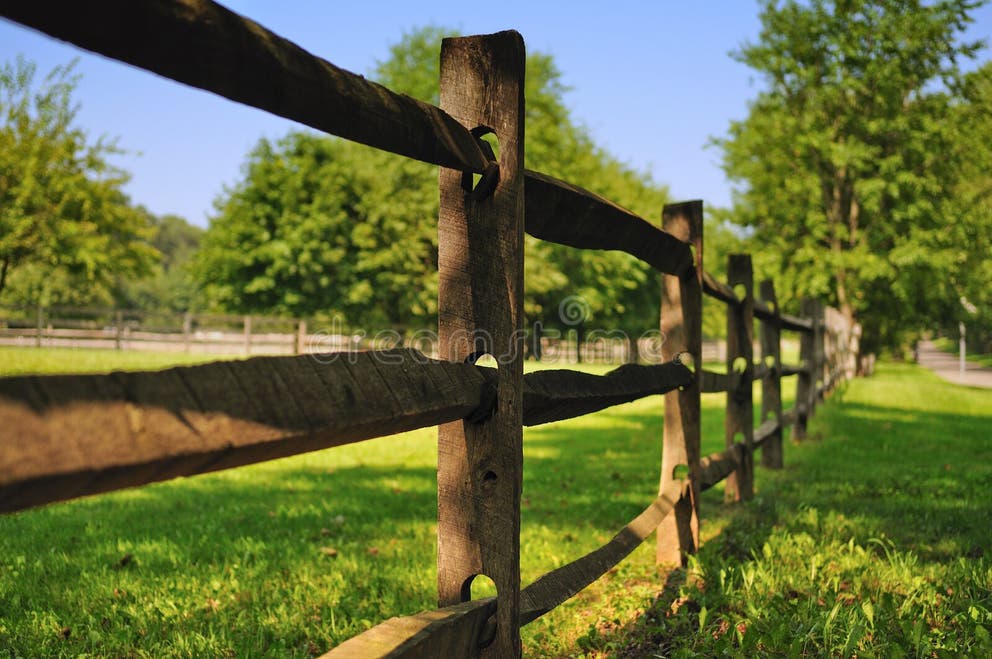 Rustic Wooden Fence in a Lush Green Meadow Stock Photo - Image of ...