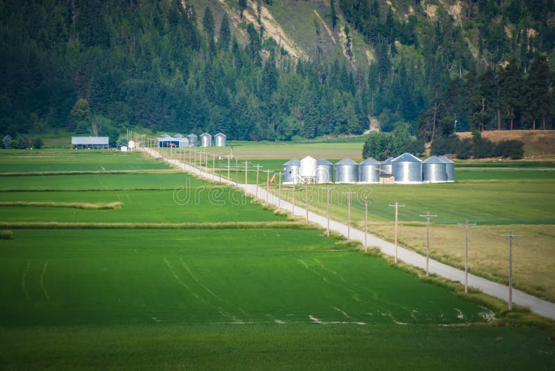 Farm Fields with Silos Near Montana Mountains Stock Image - Image of ...