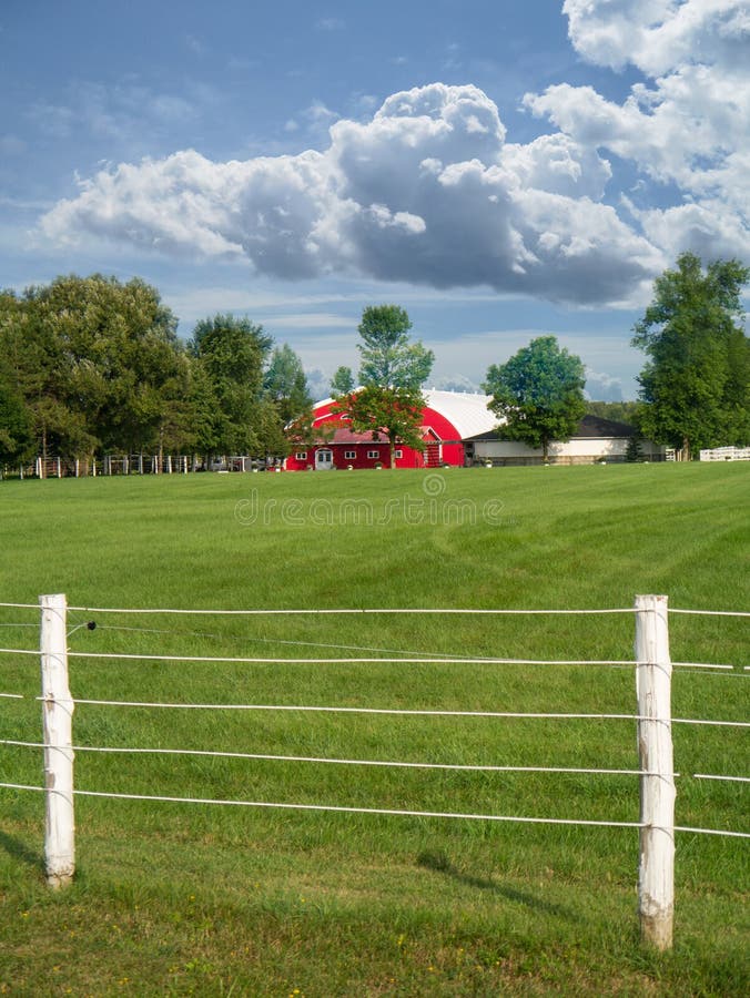 Farm with Green Grass, White Fence and Blue Skies Stock Image - Image ...