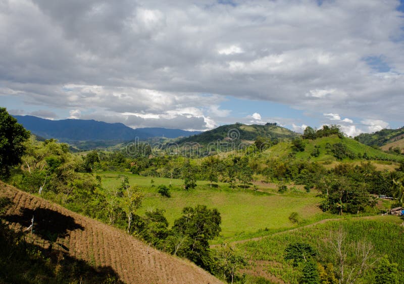 Farm, mountain and clouds stock image. Image of hill - 24298739