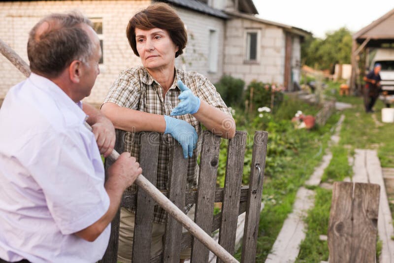 Farm Neighbors Talking at Fence Stock Photo - Image of courtyard, fence ...