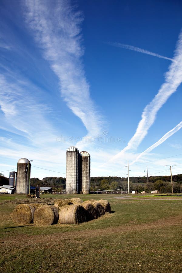 Farm Silos and Hay Bales with Contrails Stock Photo - Image of grass ...