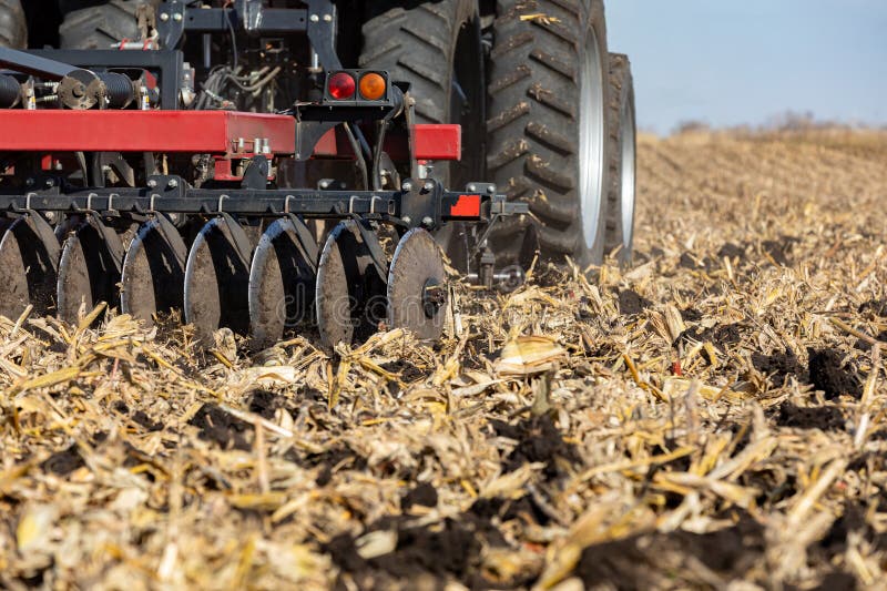 Tractor Pulling Chisel Plow Implement in Farm Field. Stock Photo ...