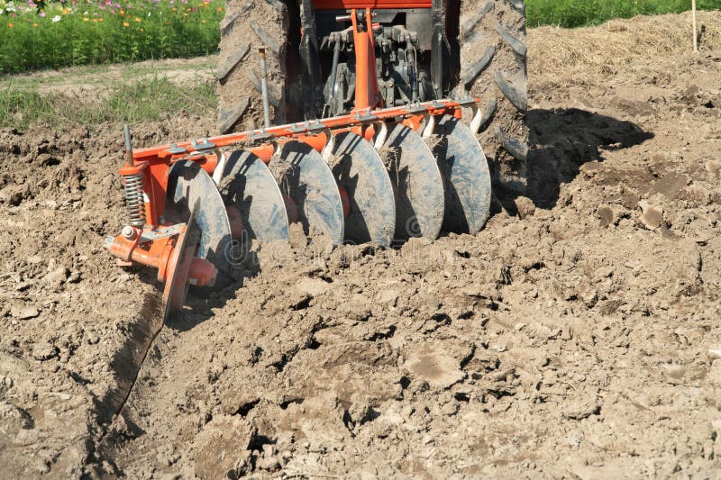 Farm Tractor Cultivating Land with a Plow Stock Photo - Image of ...