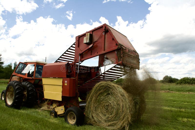 A Farmer Bales Hay Under Cloudy Skies Stock Image - Image of ...