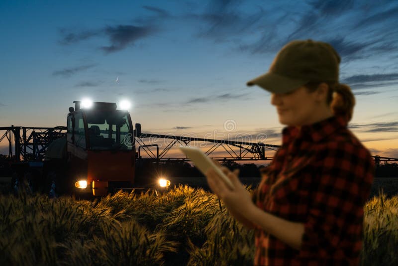 Farmer Controls Sprayer with a Tablet at Night. Stock Image - Image of ...