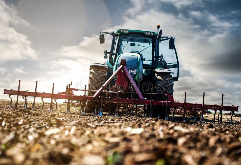 Tractor Equipped with a Harrow To Plow and Decompact His Fields Stock ...