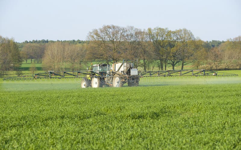Farmer fertilizing crops stock photo. Image of combine - 14348542