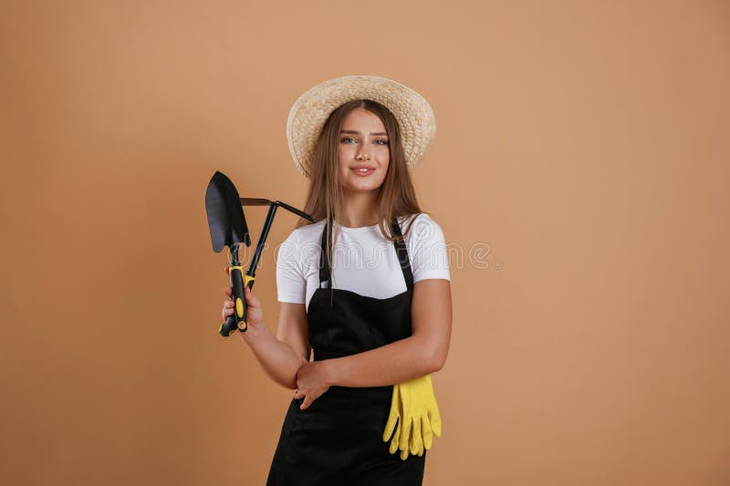 Farmer with Gardener Tools. Young Pretty Woman is Against Background in ...