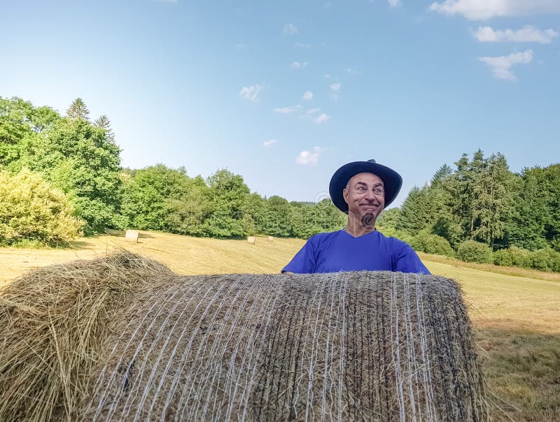 A Farmer in a Hat Stands at a Stack of Fresh Hay Stock Image - Image of ...