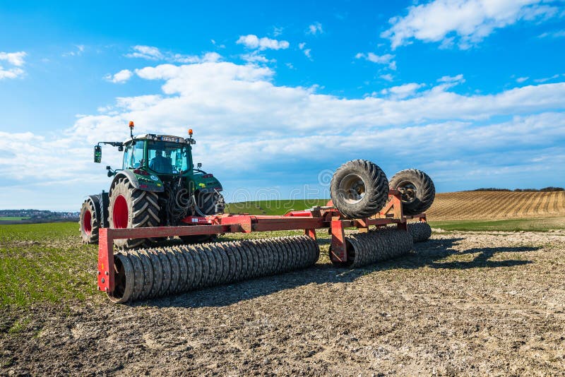 Farmer and His Tractor Equip with a Compaction Roller To Refine the ...