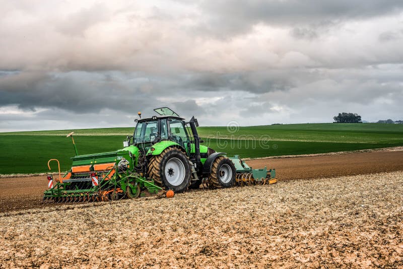 Farmer in His Tractor Sowing in the Fields Stock Photo - Image of ...
