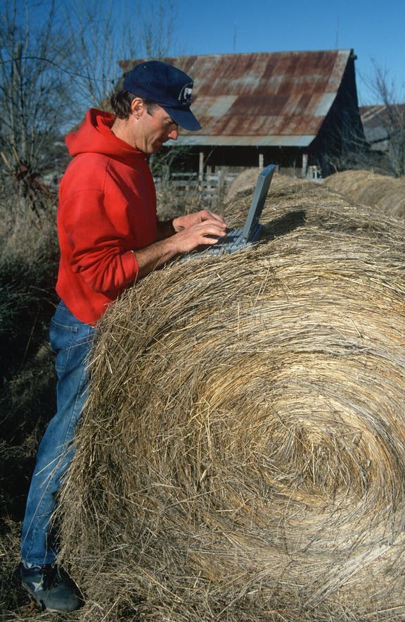 Farmer with Laptop Computer on Hay Bale Editorial Stock Image - Image ...