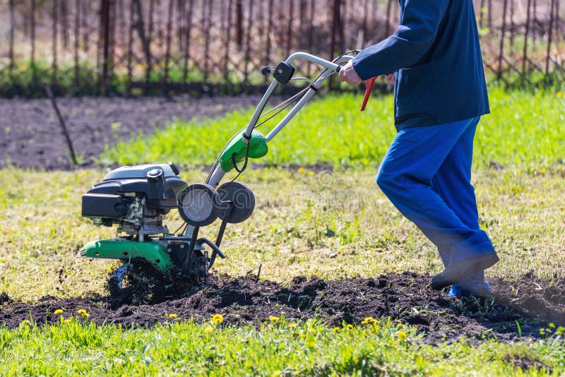 Farmer Man Plows the Land with a Cultivator Preparing the Soil for ...