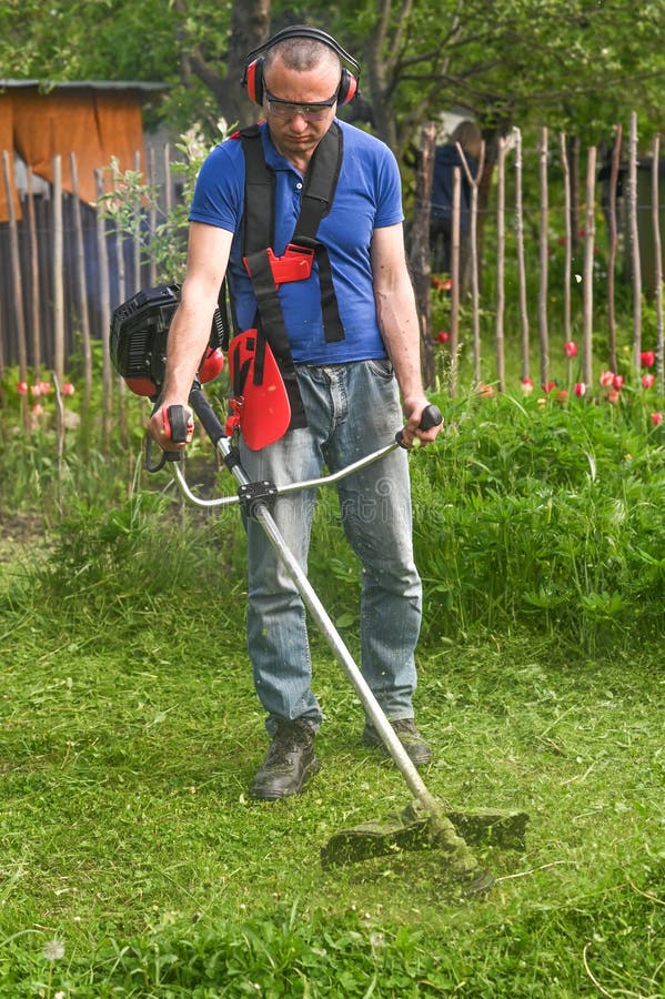 Farmer Mows the Lawn Grass with a Lawn Mower Stock Photo - Image of ...
