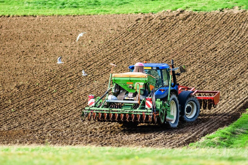 Tractor with Seeder Working in the Fields in Spring Stock Photo - Image ...