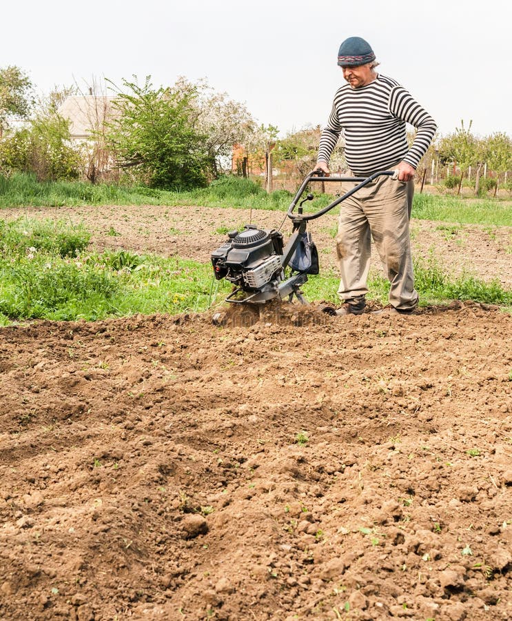 Farmer plowing the field. stock photo. Image of farming - 44107962