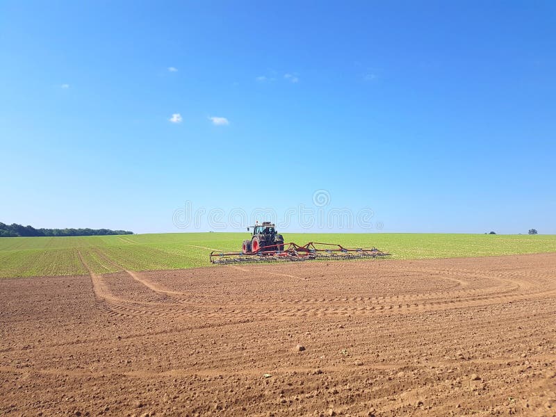 Farmer is Plowing a Field with Tractor Stock Photo - Image of ...