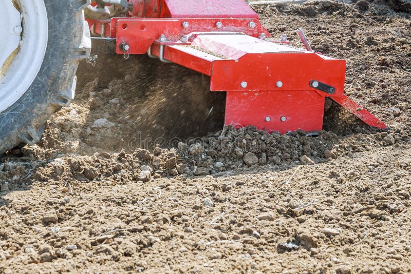 Farmer Plows the Field. Small Tractor with a Plow in the Field ...