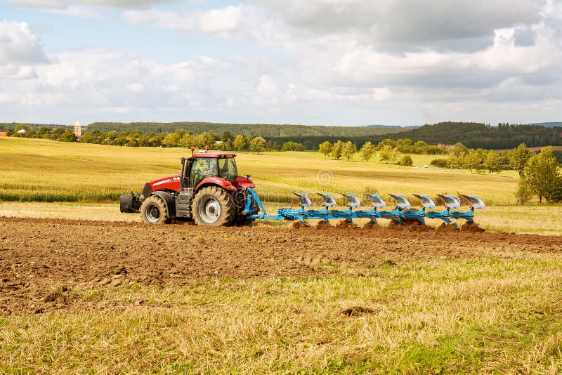 Plow the Land. Farmer in Red Tractor Preparing Land with Plow for ...