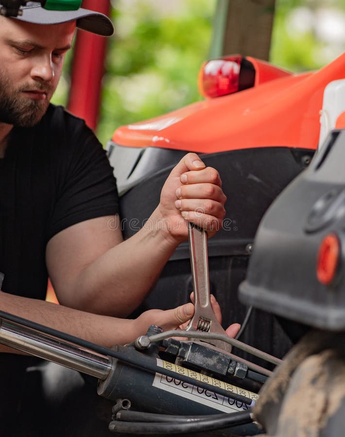 The Farmer Repairs Agricultural Machines Stock Photo - Image of service ...