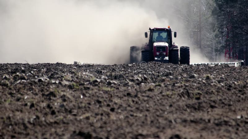 Farmer on a Powerful Tractor Handles Heavy Swampy Black Soil with a ...