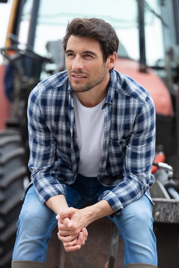 Farmer Sits on Tractor and Looking Away Stock Photo - Image of ...