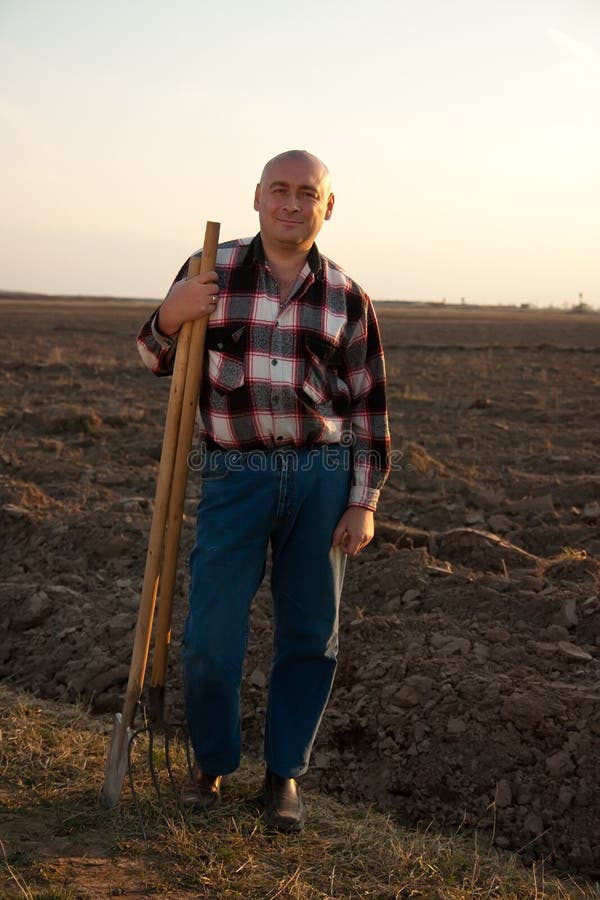 Farmer with Spade and Pitchfork Stock Photo - Image of occupation, dusk ...