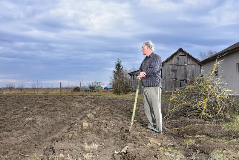 Farmer Standing with a Shovel on the Field Stock Photo - Image of ...