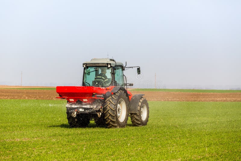 Farmer in Tractor Fertilizing Wheat Field at Spring with Npk Stock ...