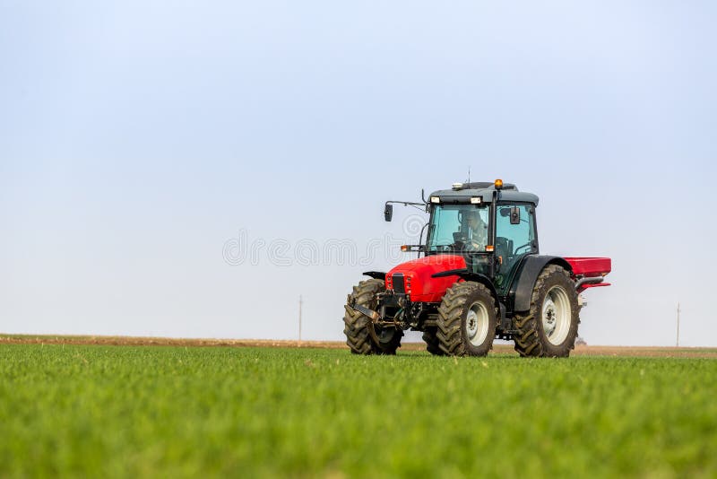 Farmer in Tractor Fertilizing Wheat Field at Spring with Npk Stock ...