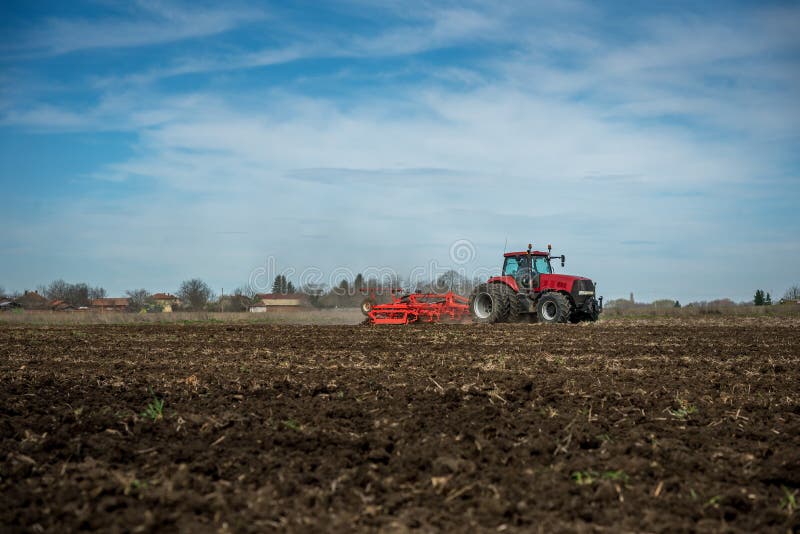 Tractor plowing fields. stock photo. Image of farming - 115602436